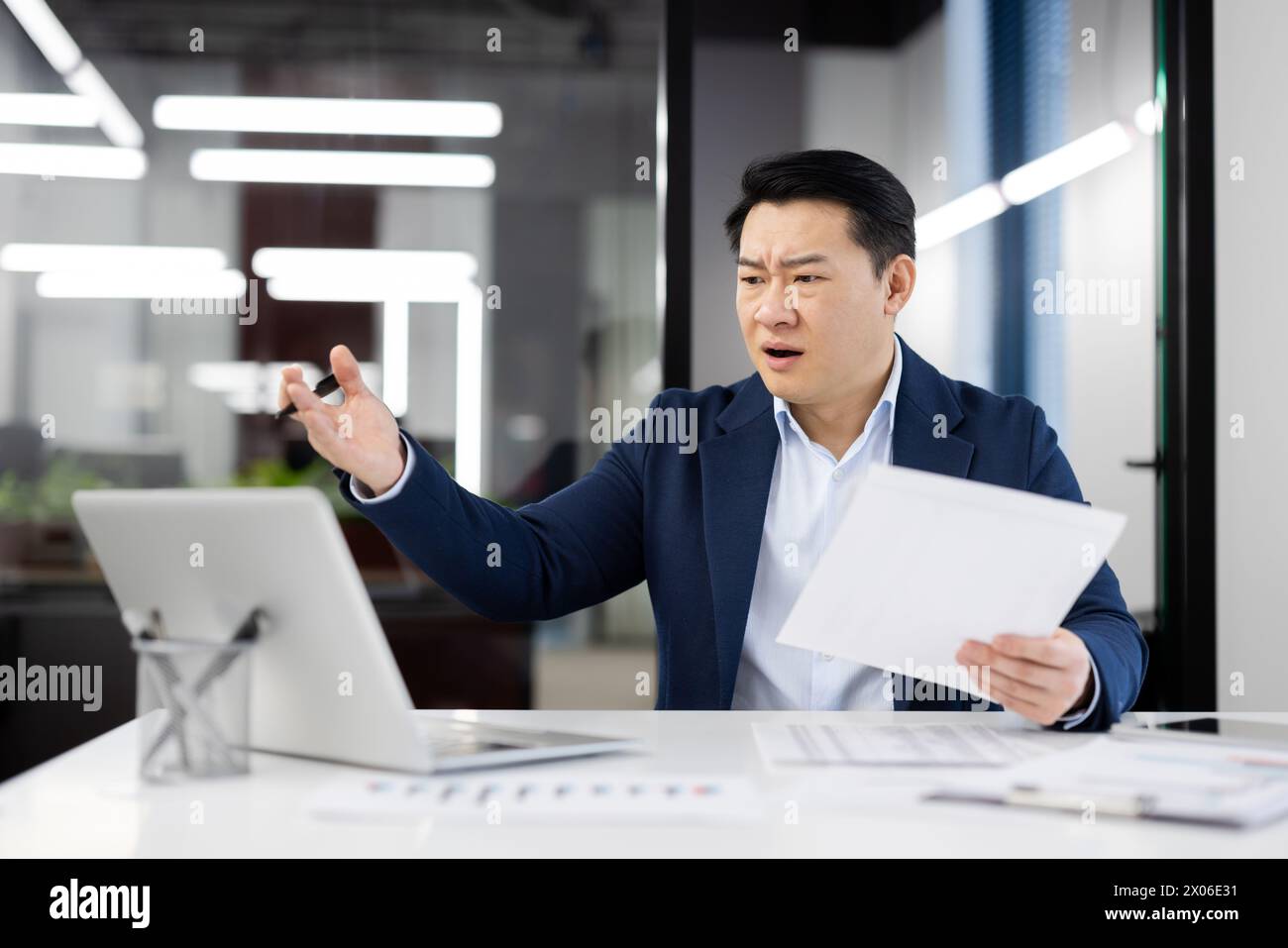 A confused and overwhelmed businessman working in the office ...