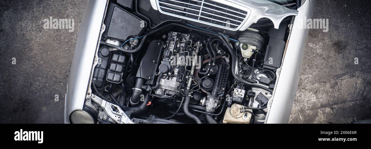 Car engine top view. Open car hood showing detailed auto components ...