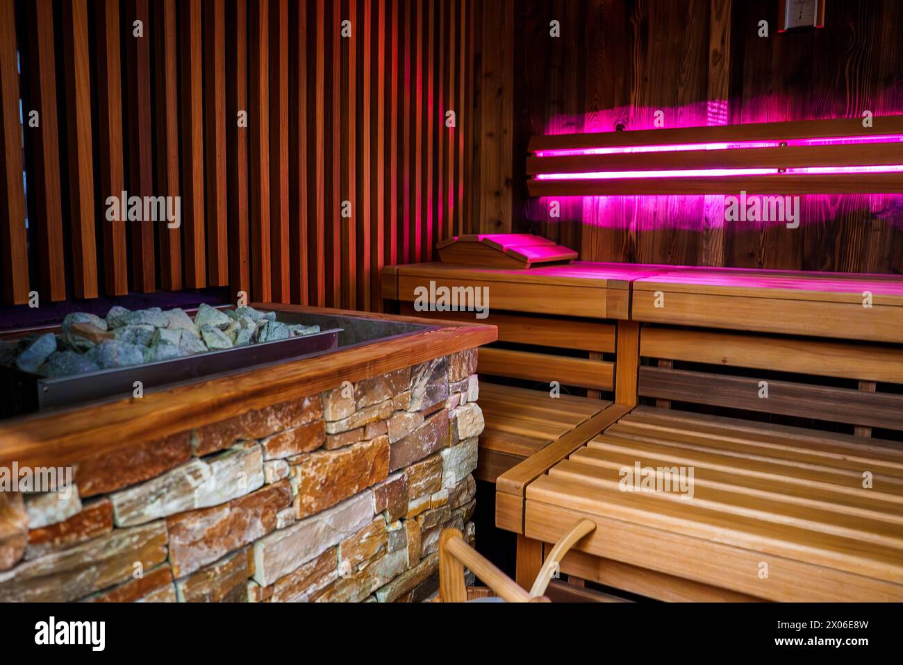 Sauna Interior with Stone Heater, Wooden Benches and Ambient Lighting ...