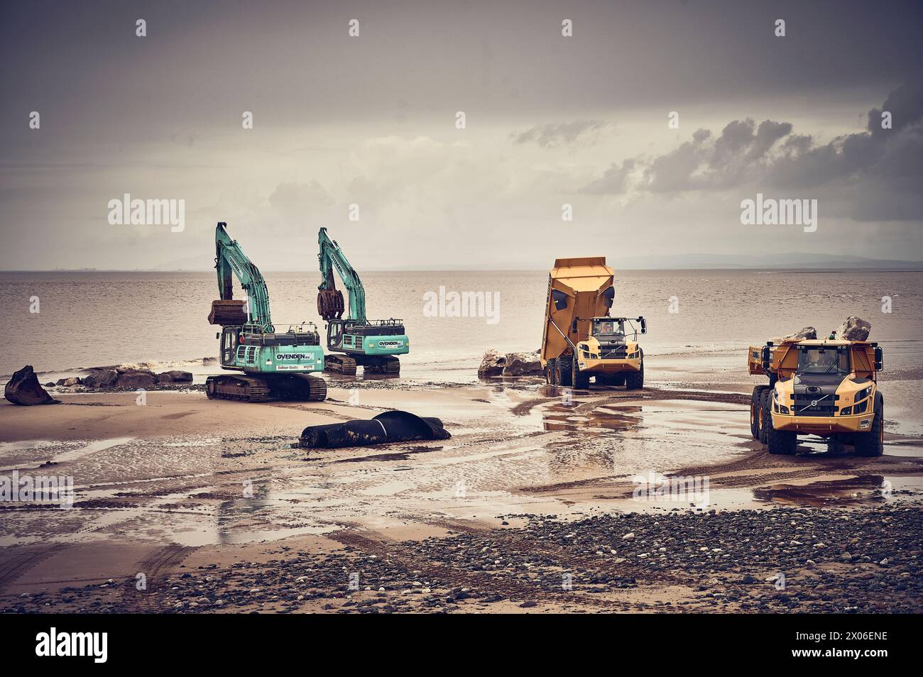 Building rock groynes on the beach at Fleetwood Stock Photo - Alamy