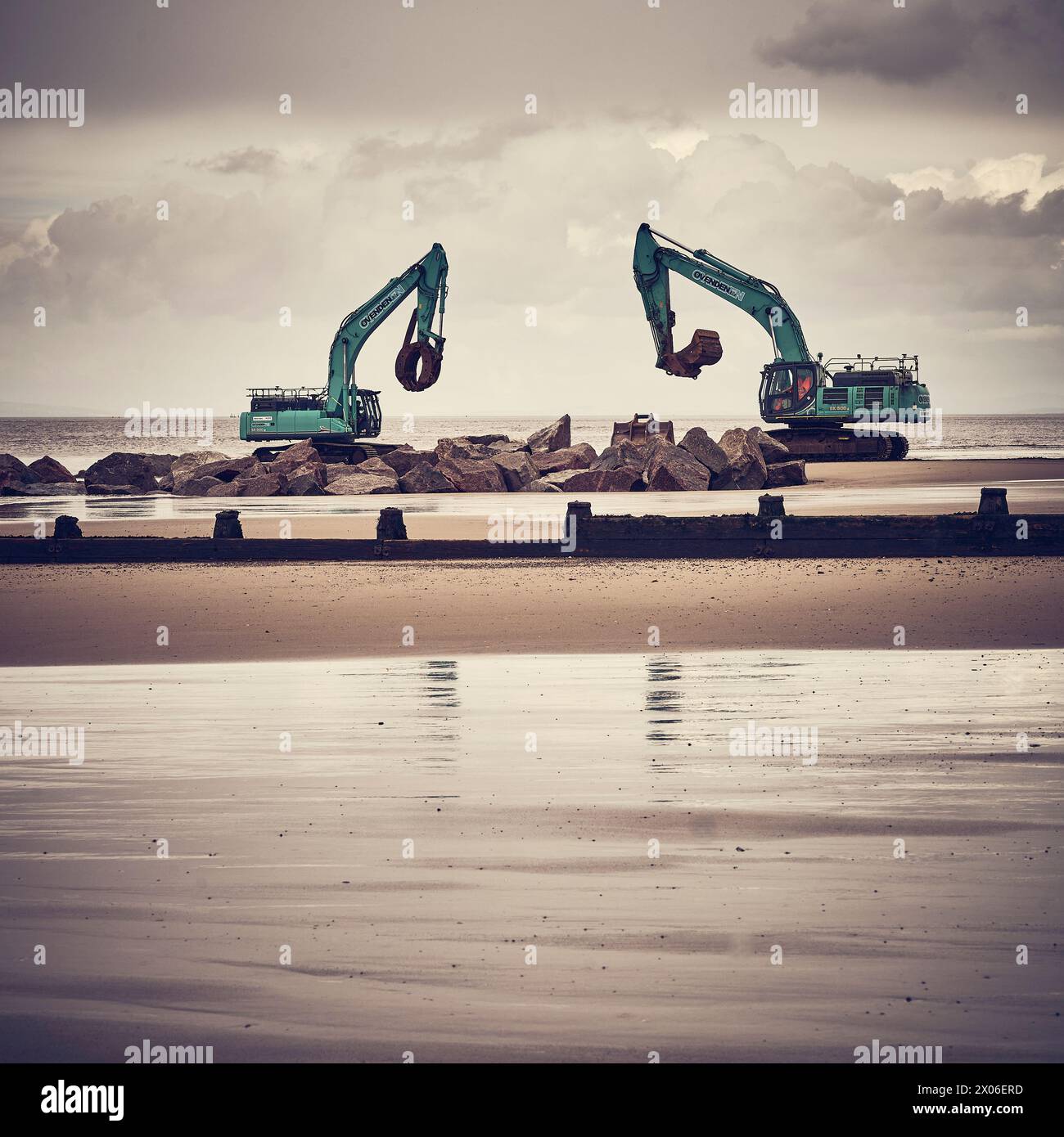 Building rock groynes on the beach at Fleetwood Stock Photo - Alamy