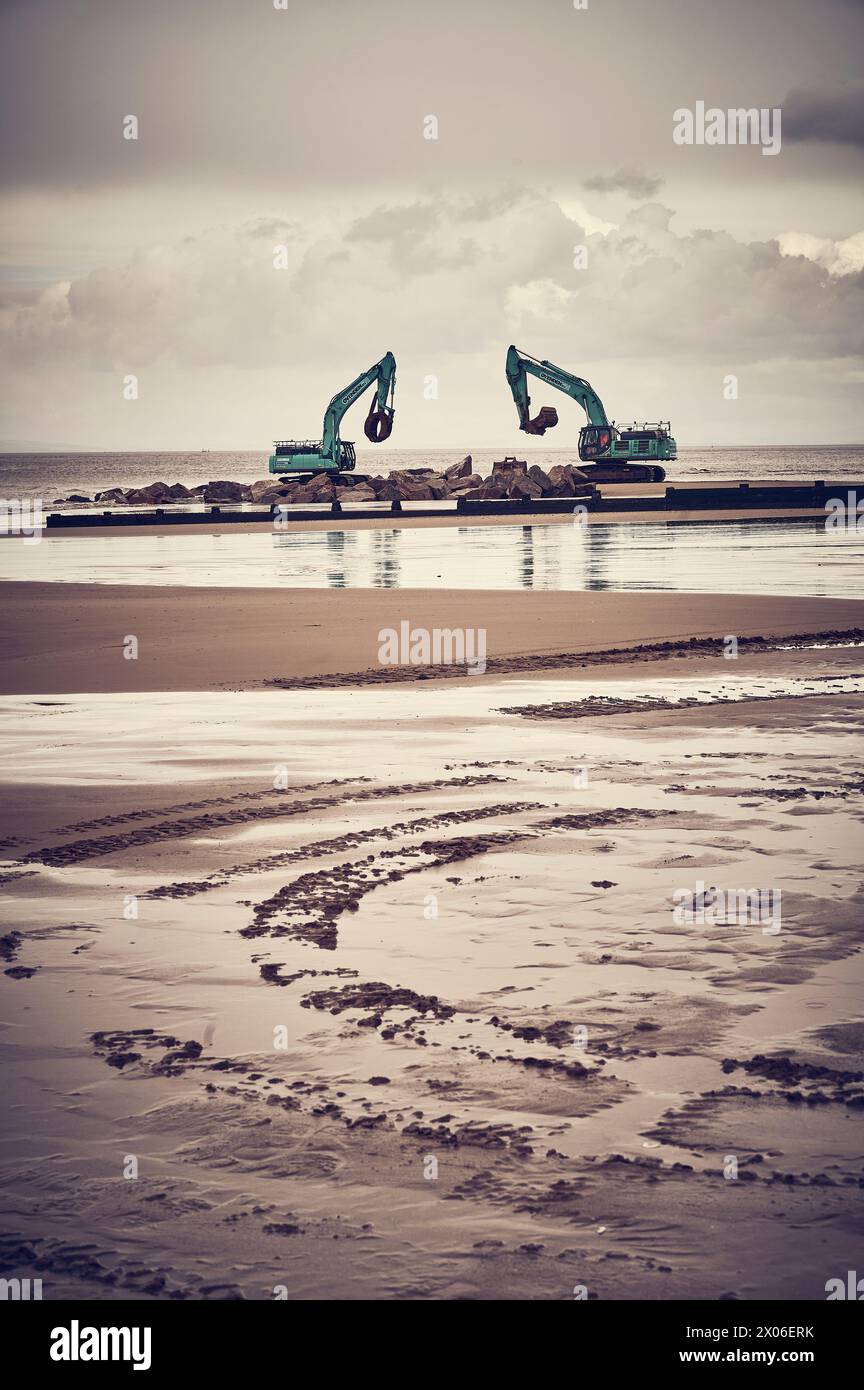 Building rock groynes on the beach at Fleetwood Stock Photo - Alamy