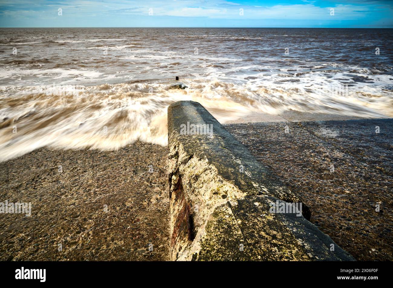 Damage to seawall caused by constant battering by the sea Stock Photo ...