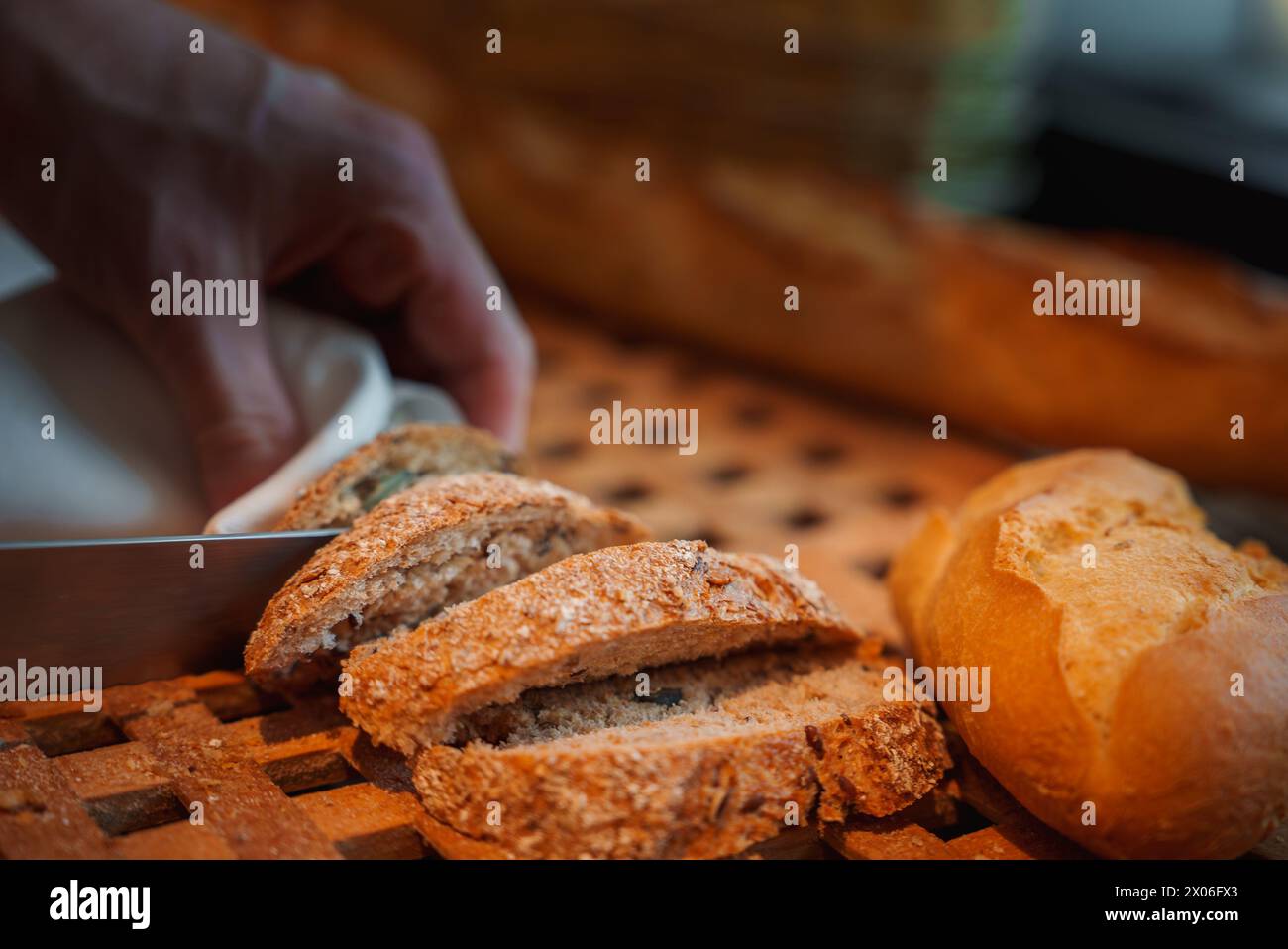 Luxury hotel dining experience showcasing fresh bread slices being cut ...