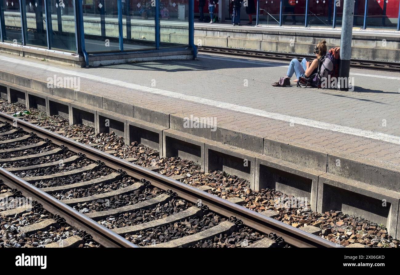A female backpacker waits for the train at Buchloe railway station on ...