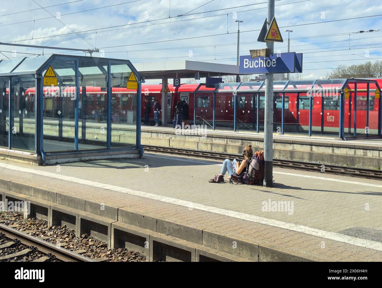 A female backpacker waits for the train at Buchloe railway station on ...