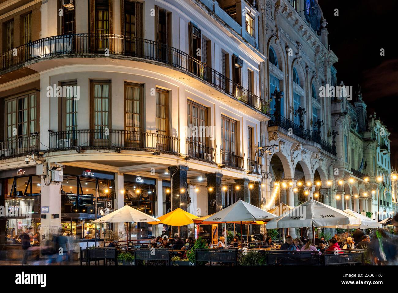People Sitting Outside A Cafe/Restaurant On The Corner of Plaza 9 de ...