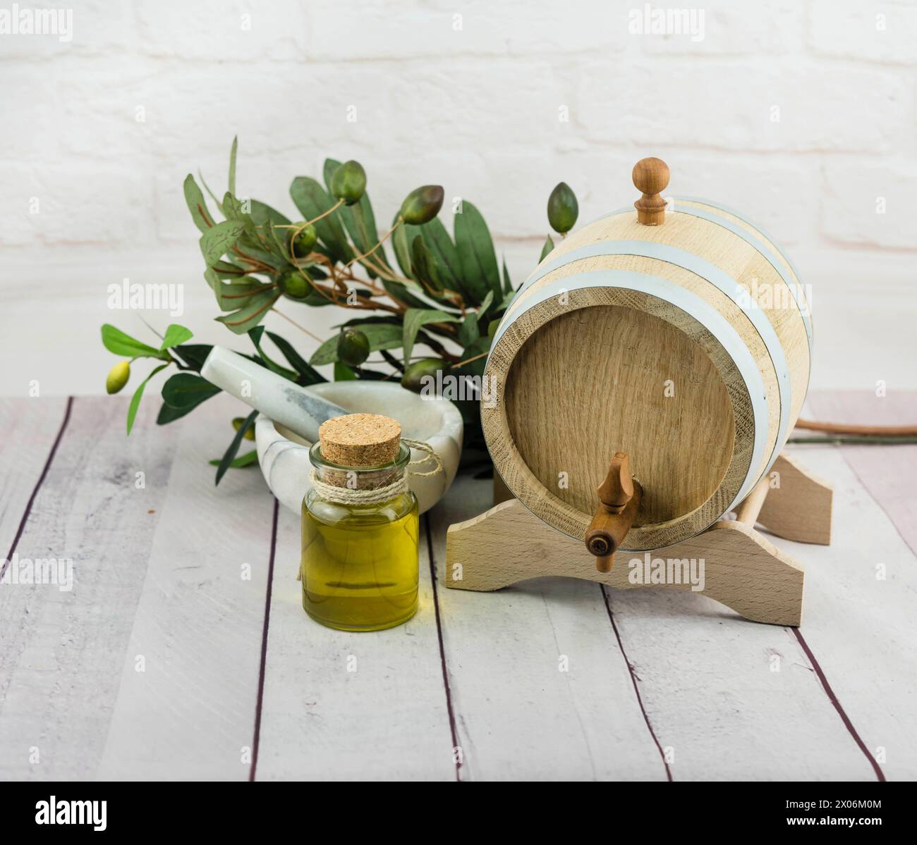 Olive branch, mortar, olive oil and wooden barrel Stock Photo - Alamy