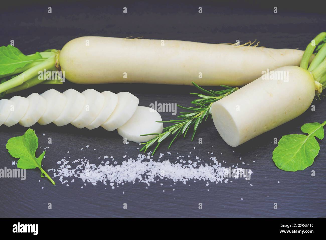 Garden radish (Raphanus sativus), Two radishes on a black background ...