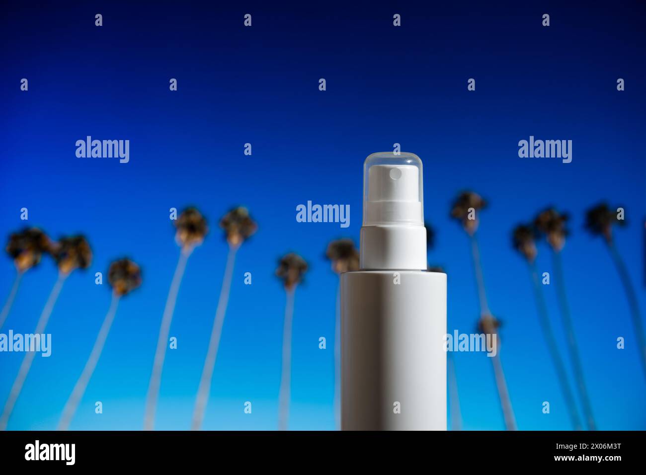 Blank white sunscreen bottle against blue sky and palm trees. Summer ...
