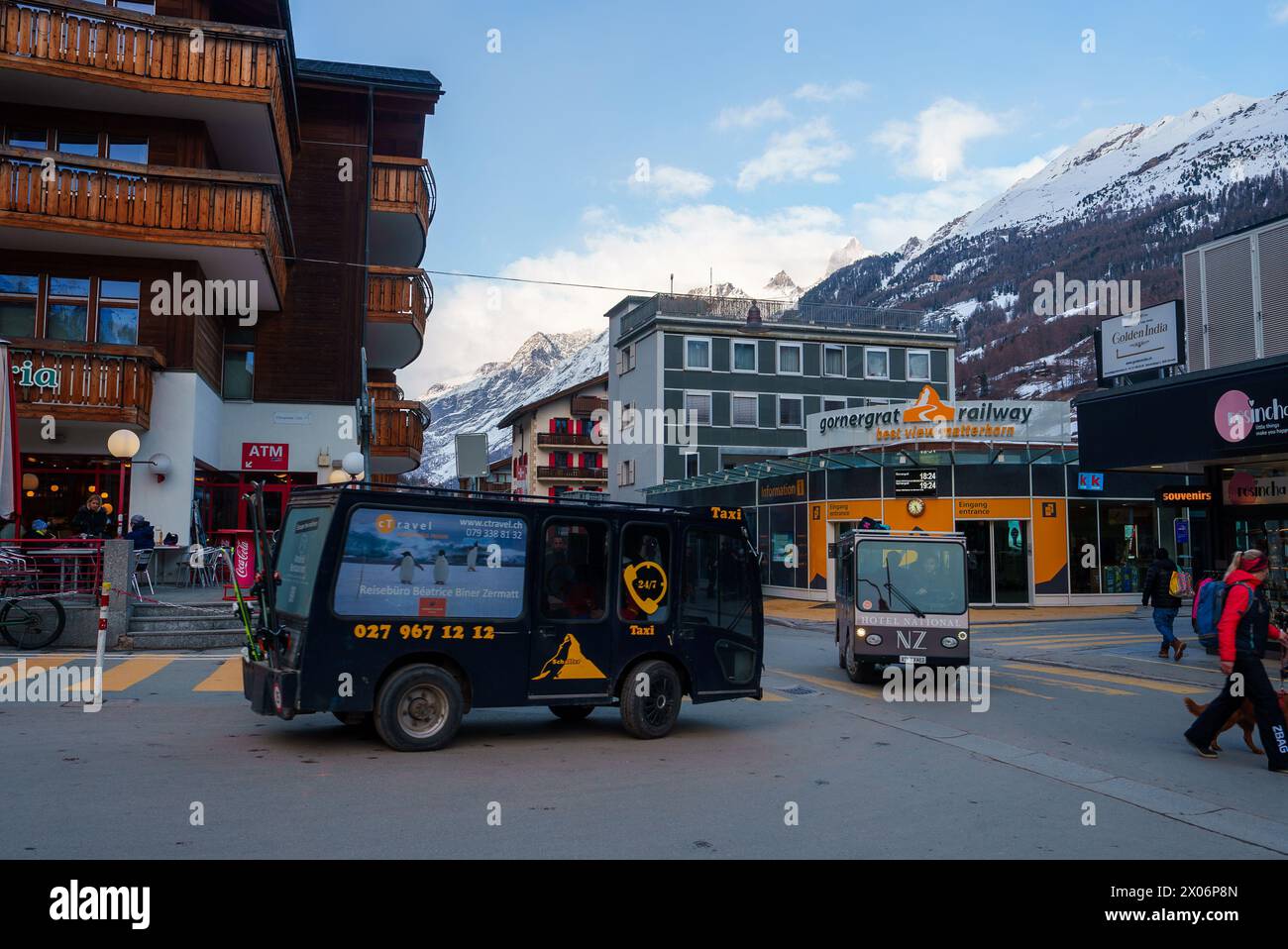 Bustling street scene in Zermatt, Switzerland, with electric taxis ...