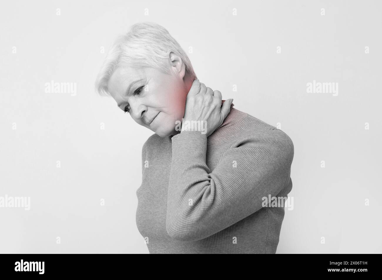 Senior woman grasping her neck, monochrome photo Stock Photo - Alamy