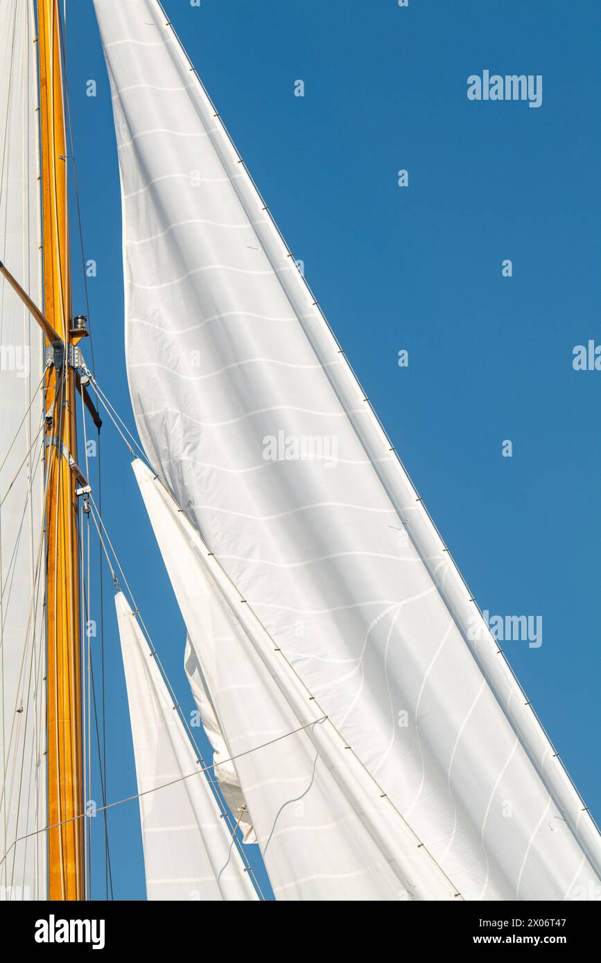 White Dacron sails on a classic wooden sail boat with wooden masts ...