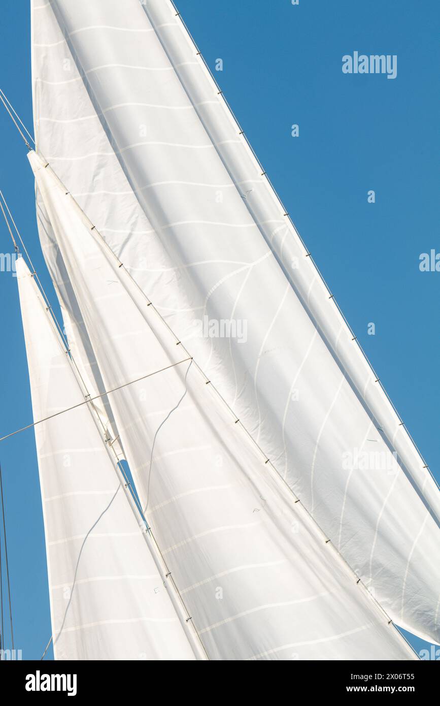 White Dacron sails on a classic wooden sail boat with wooden masts ...