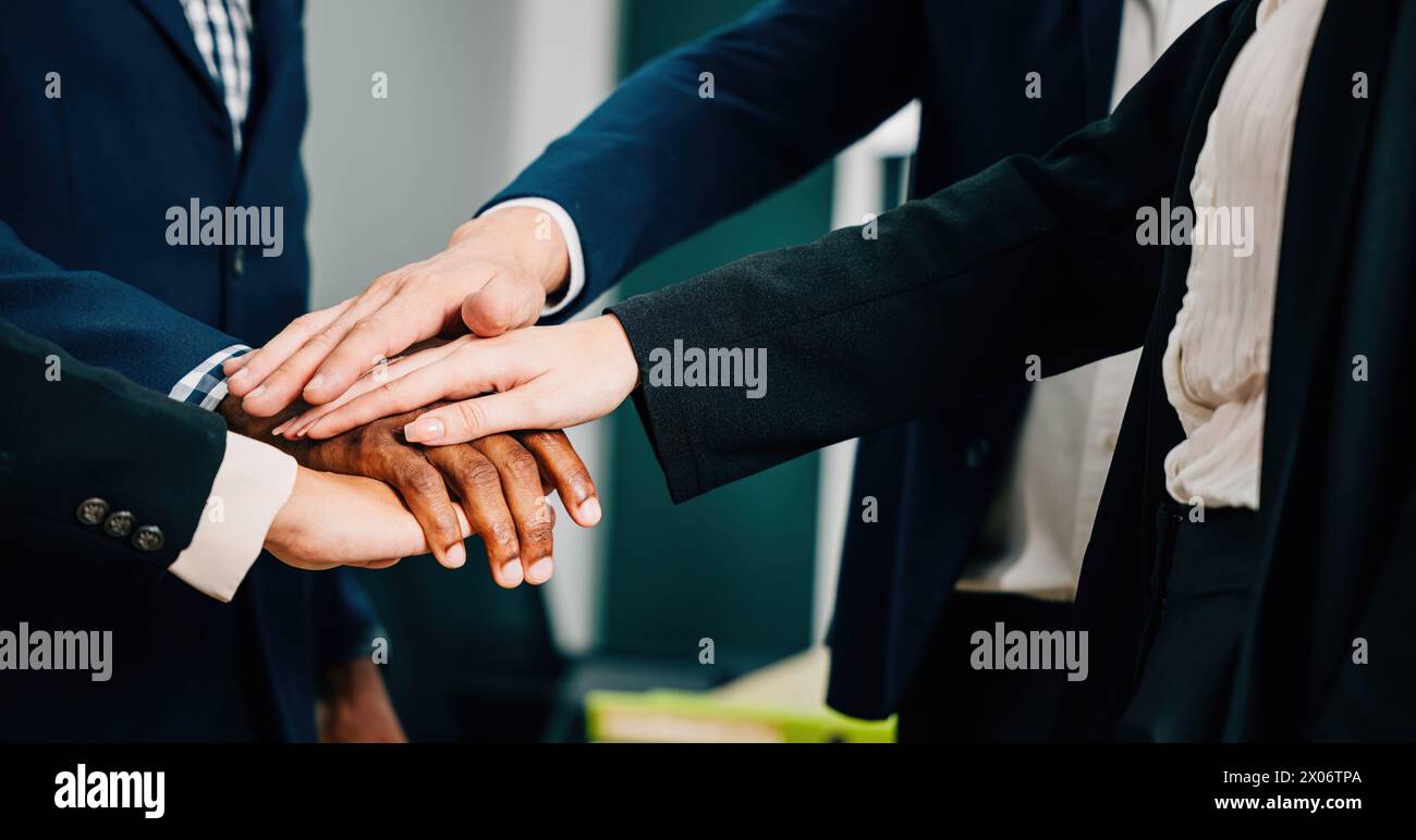 Entrepreneurs and employees unite in a modern office, forming a circle ...