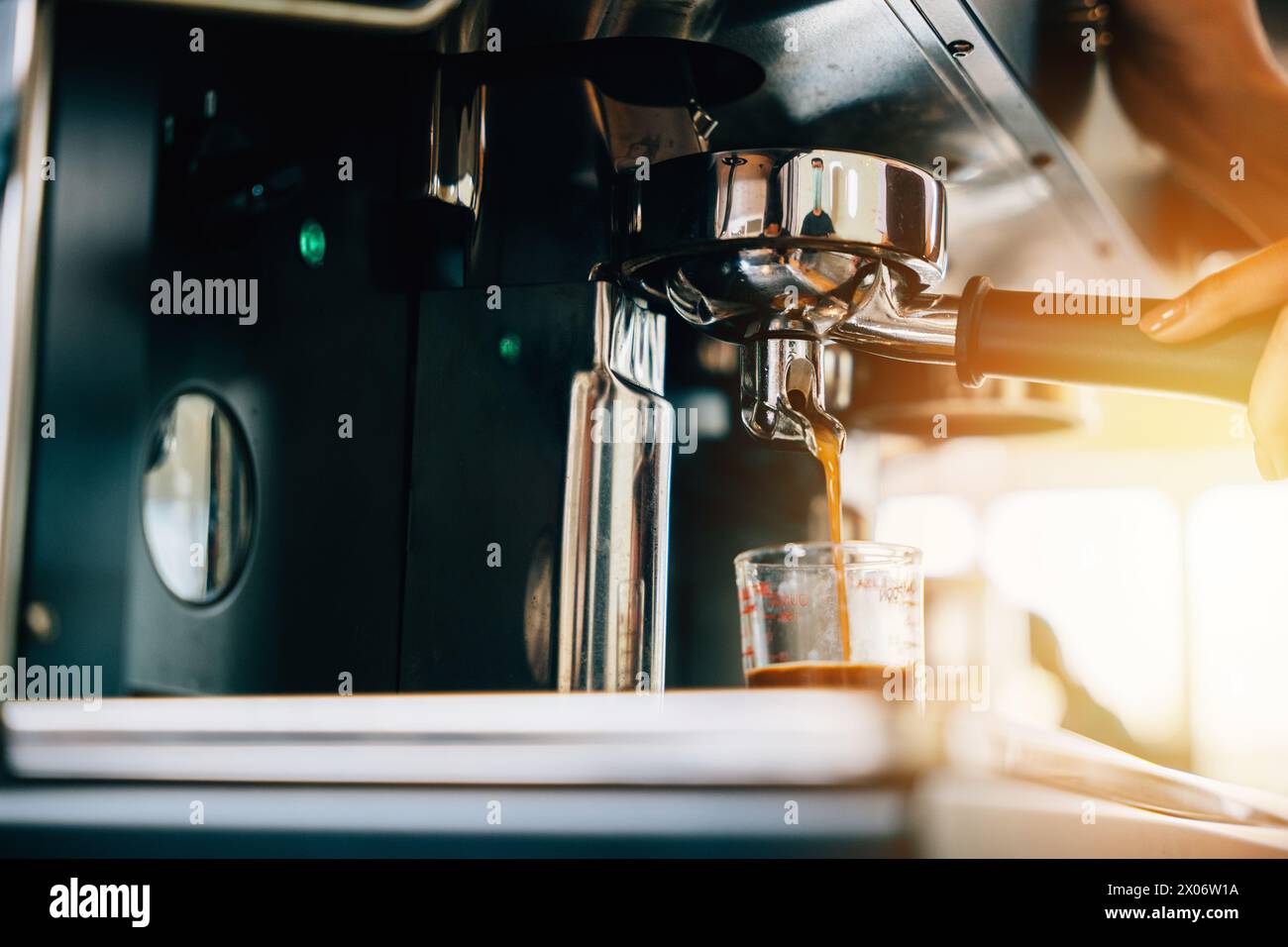 At cafe shop coffee pours from espresso machine. Modern technology ...