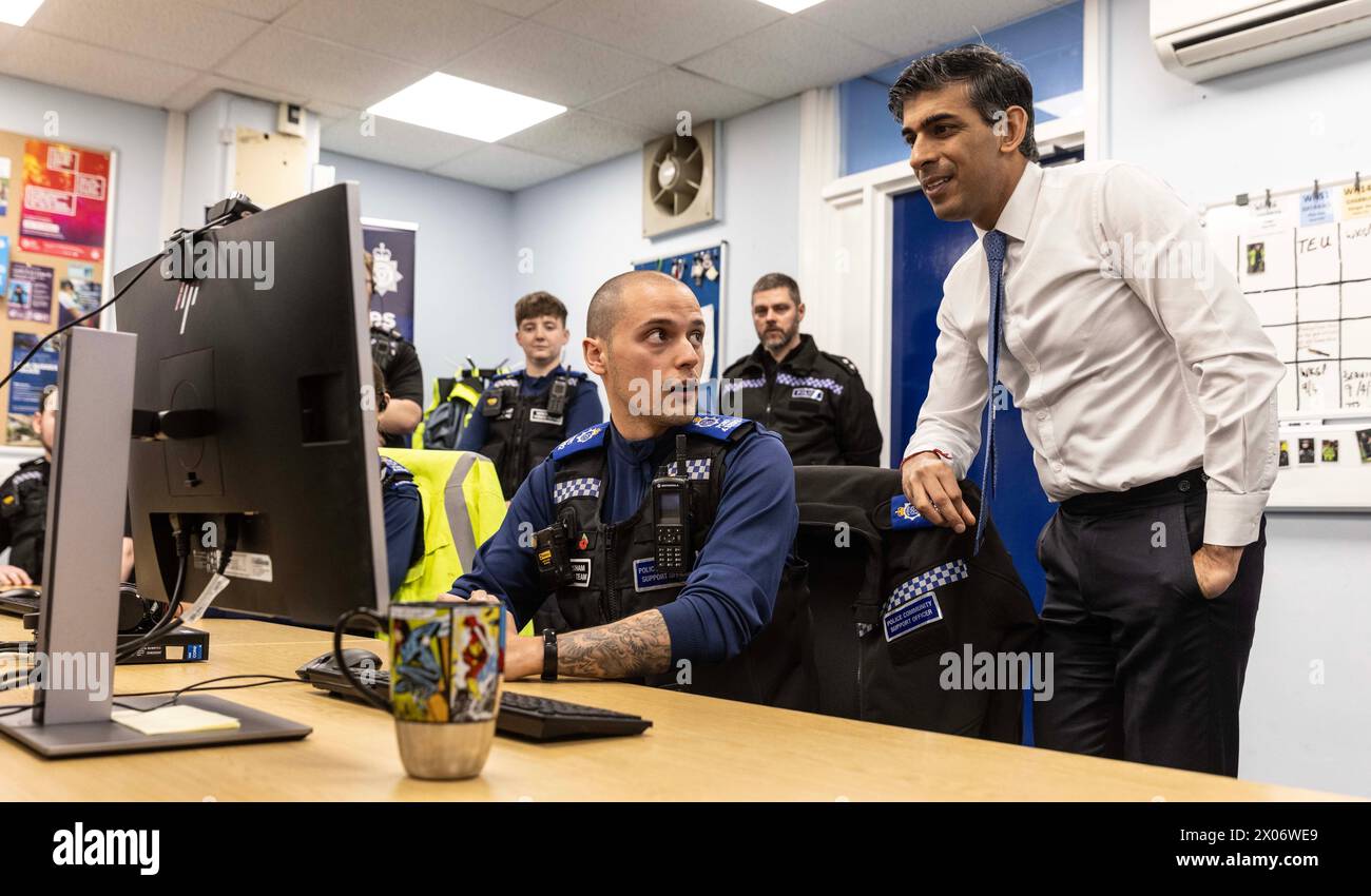 Prime Minister Rishi Sunak (right) is shown CCTV footage of shop ...