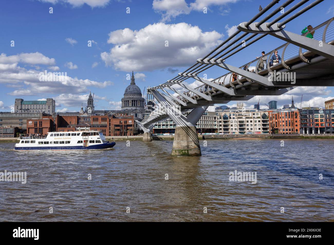 Sightseeing boat under Millennium Bridge, suspension bridge over River ...