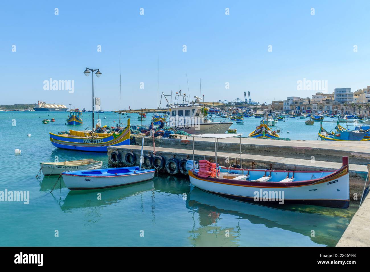 Marsaxlokk, Malta - March 23rd 2022: Various boats moored alongside a ...