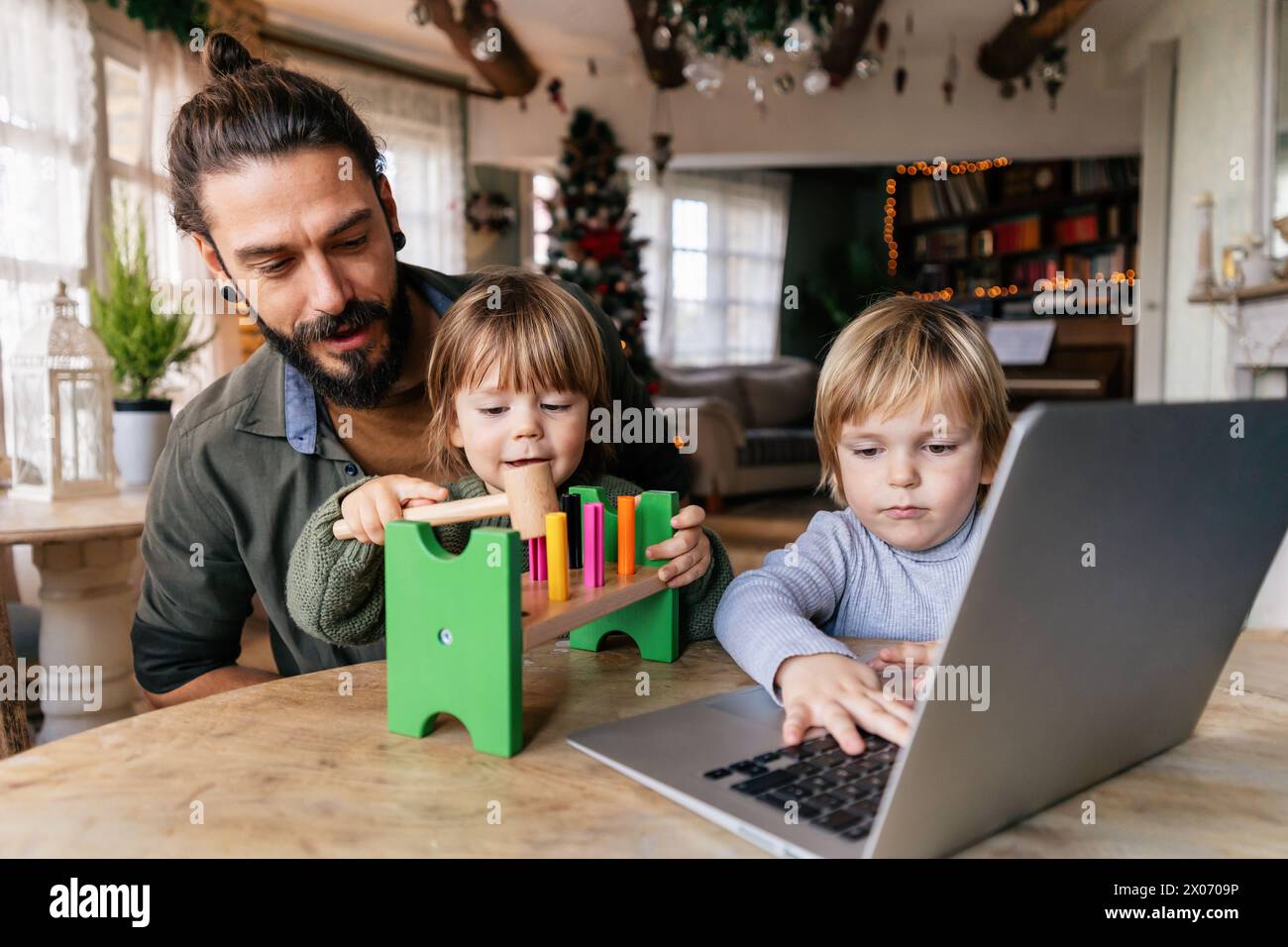 Multi-tasking freelance and fatherhood concept. Working single father ...