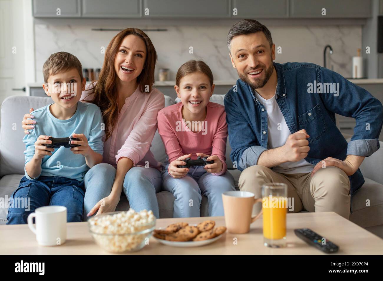 Family having fun playing video games together Stock Photo - Alamy