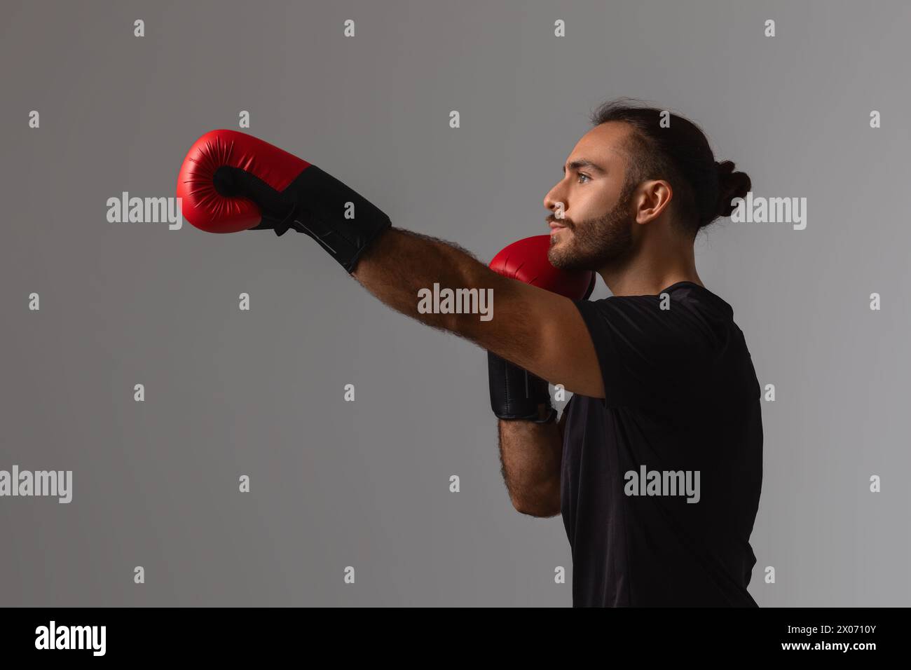 Man boxing with red gloves on grey background Stock Photo - Alamy