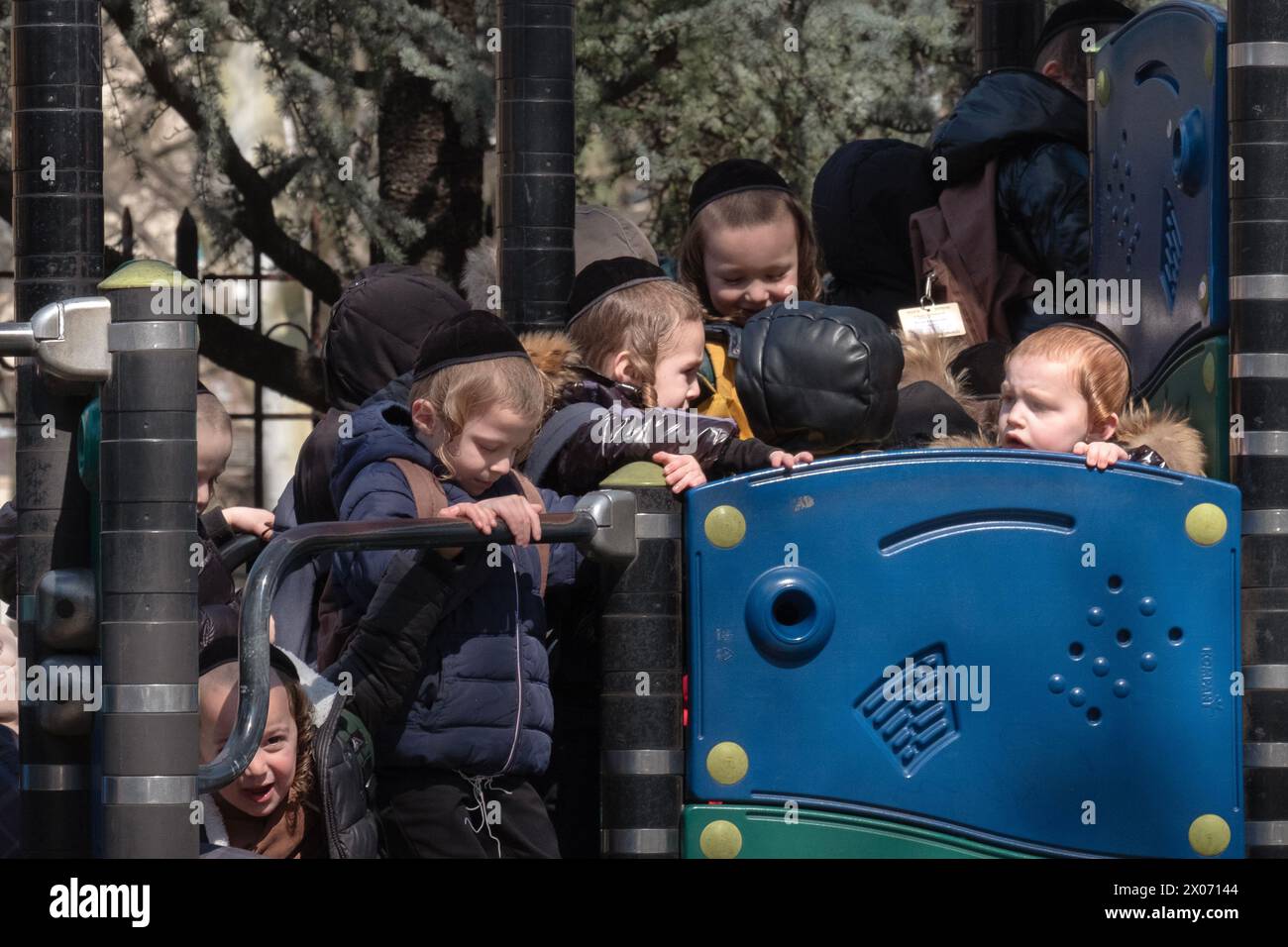 Orthodox jewish yeshiva students spend recess in a playground in ...