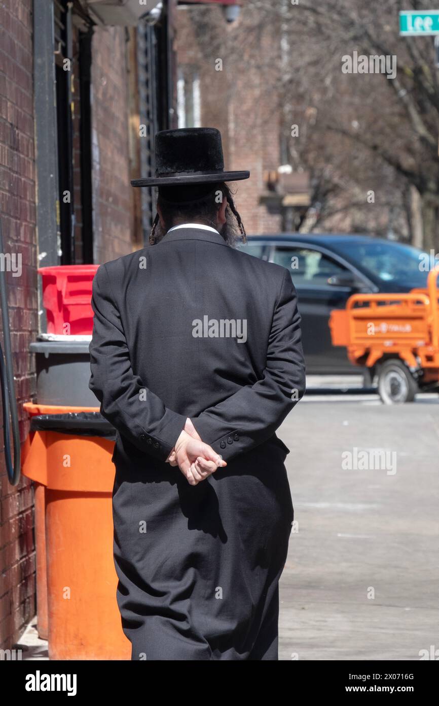 A generic anonymous photo of a Hasidic Jewish man walking away from the ...