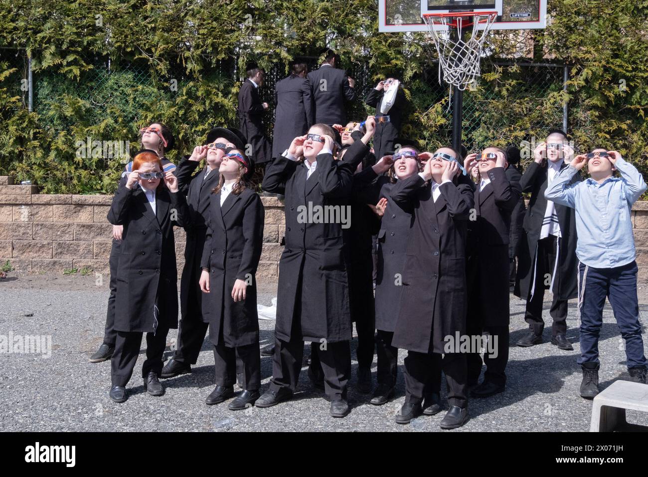 A group of orthodox Jewish boys watch the 2024 solar eclipse from the ...