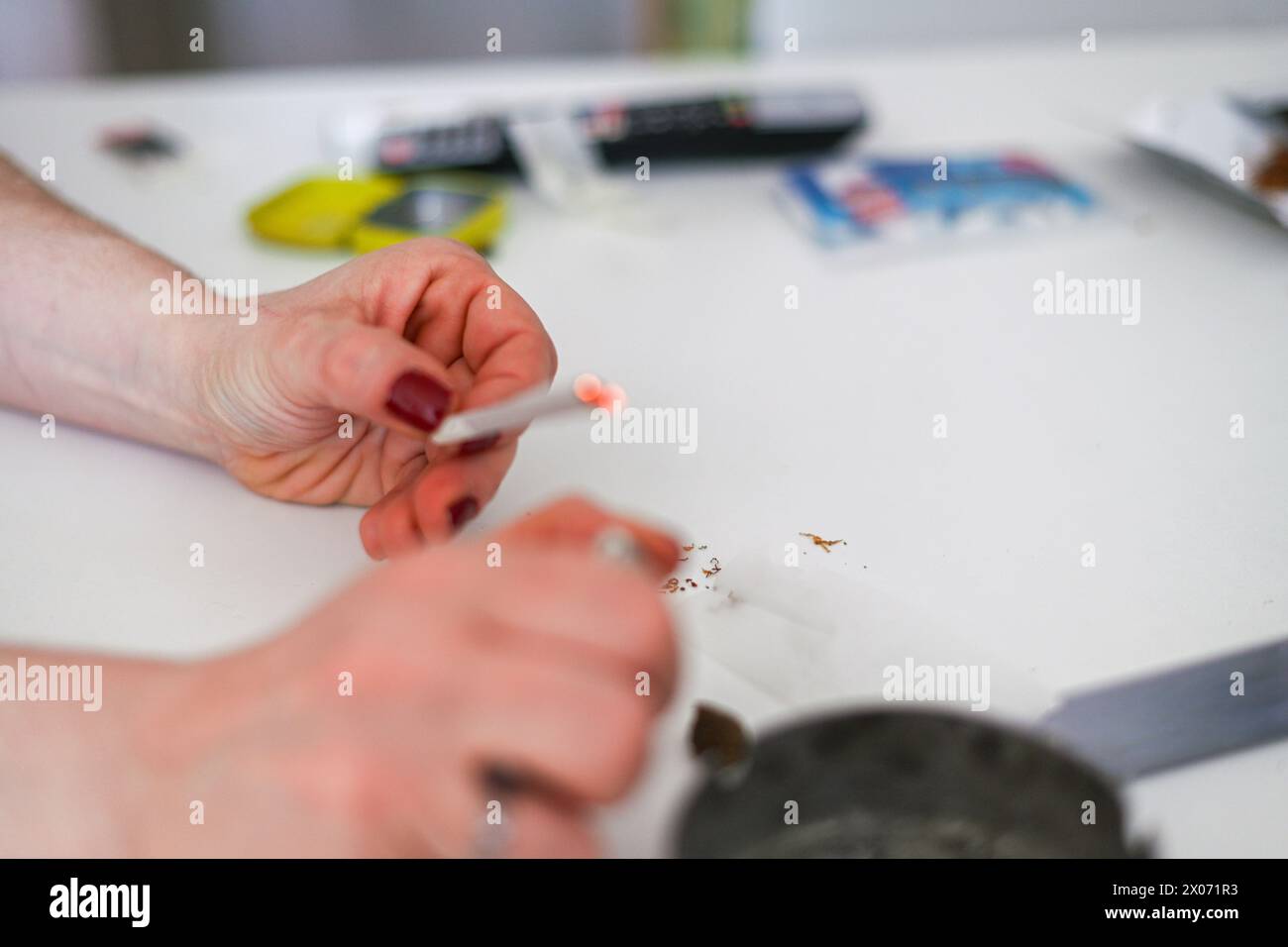unrecognizable female young adult person prepare smoke hashish tobacco ...