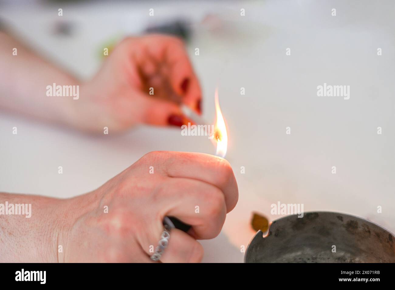 unrecognizable female young adult person prepare smoke hashish tobacco ...