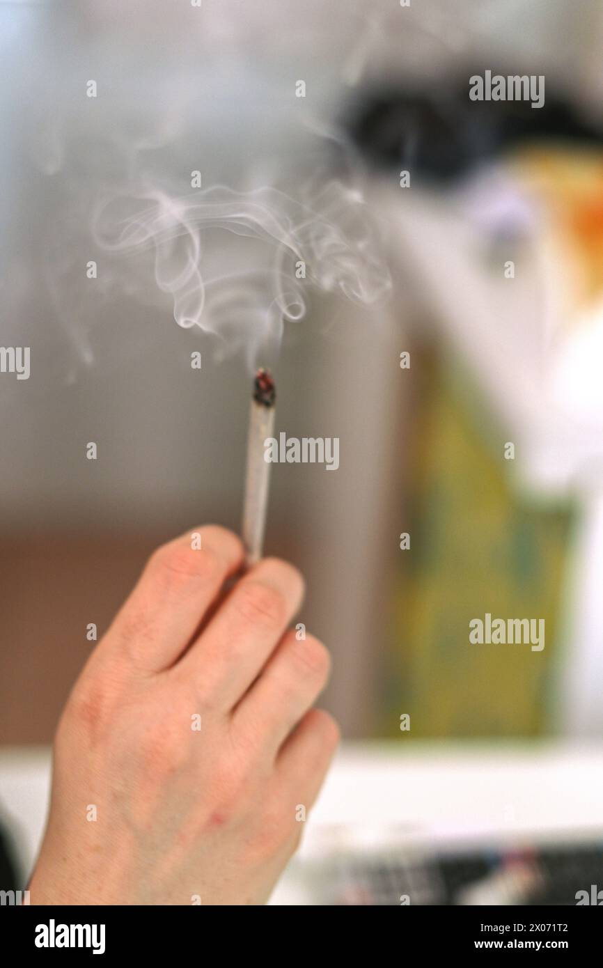 unrecognizable female young adult person prepare smoke hashish tobacco ...