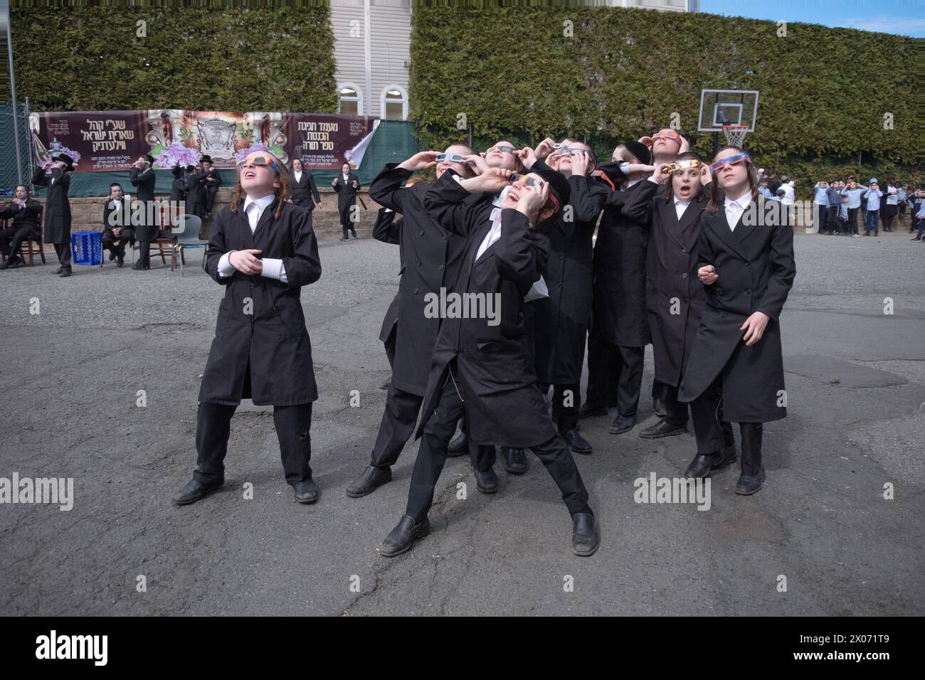 A group of orthodox Jewish students observe the 2024 Solar Eclipse from ...