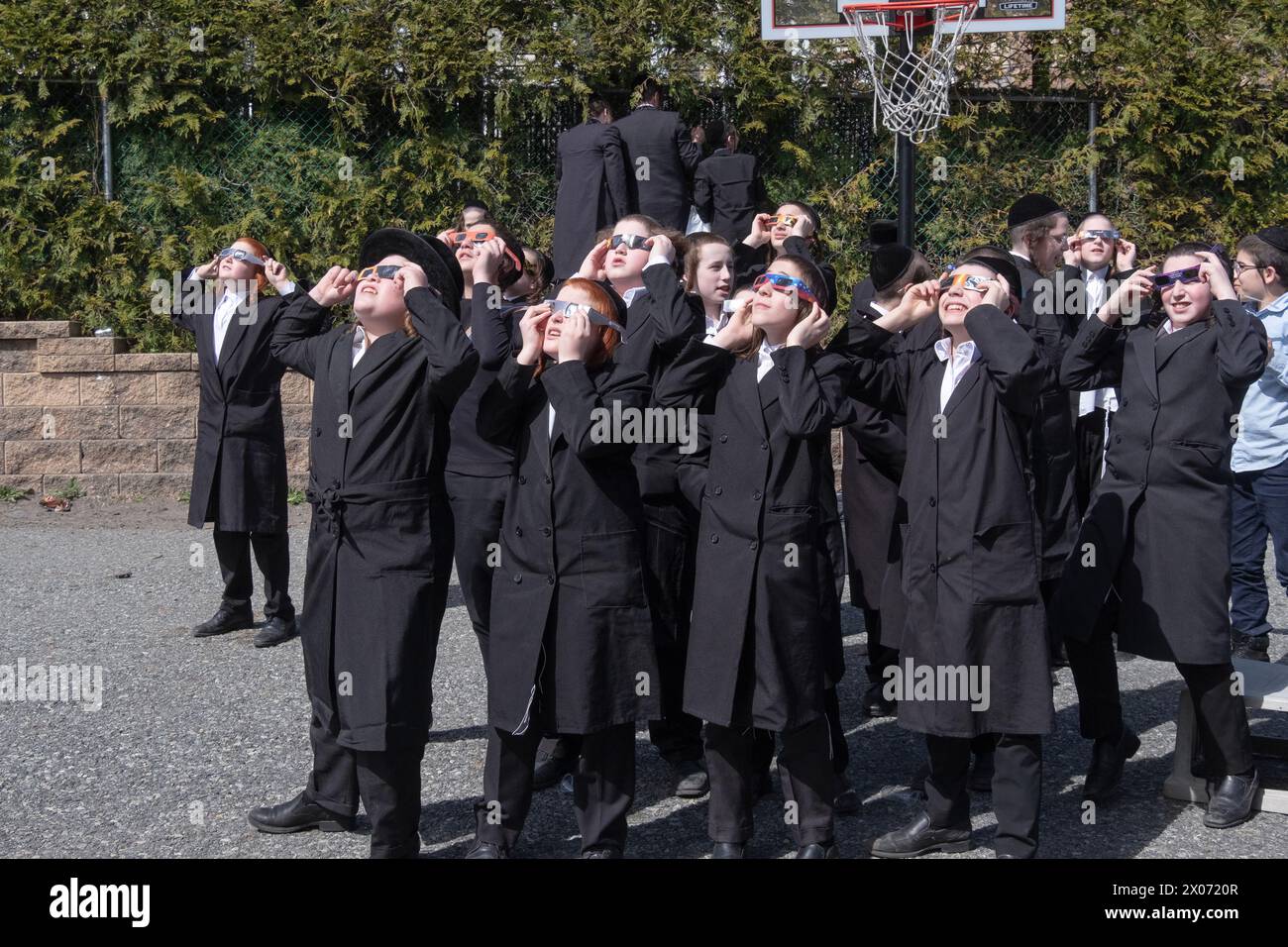 A group of orthodox Jewish boys watch the 2024 solar eclipse from the ...