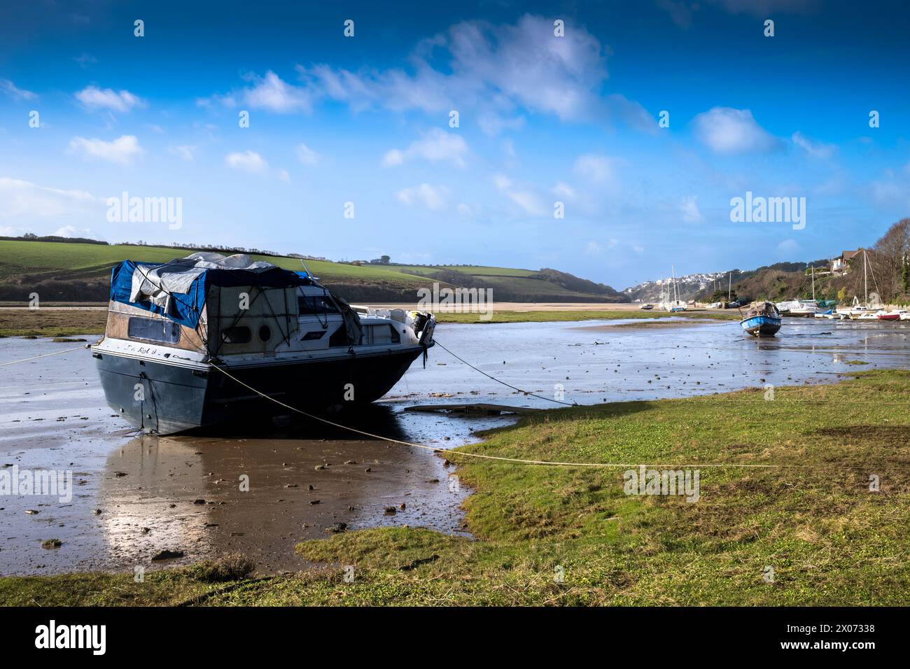 Boats moored at low tide on the tidal Gannel Estuary in Newquay in ...