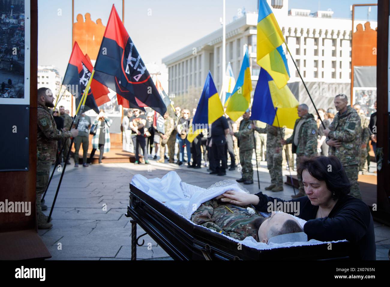 KYIV, UKRAINE - APRIL 9, 2024 - A woman kneels at the coffin during the ...