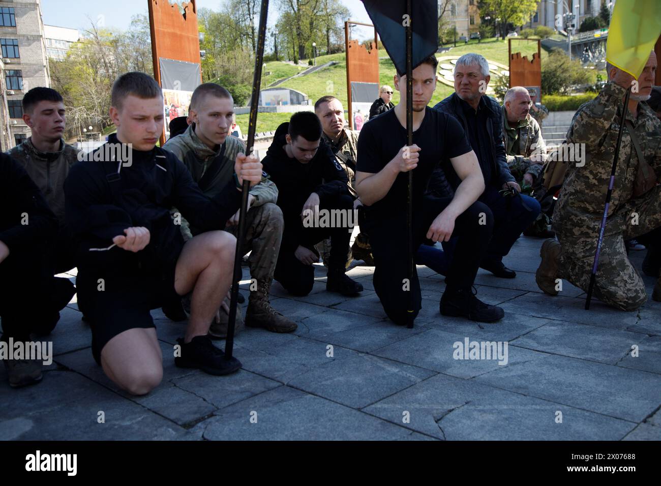KYIV, UKRAINE - APRIL 9, 2024 - People kneel to express their respect ...