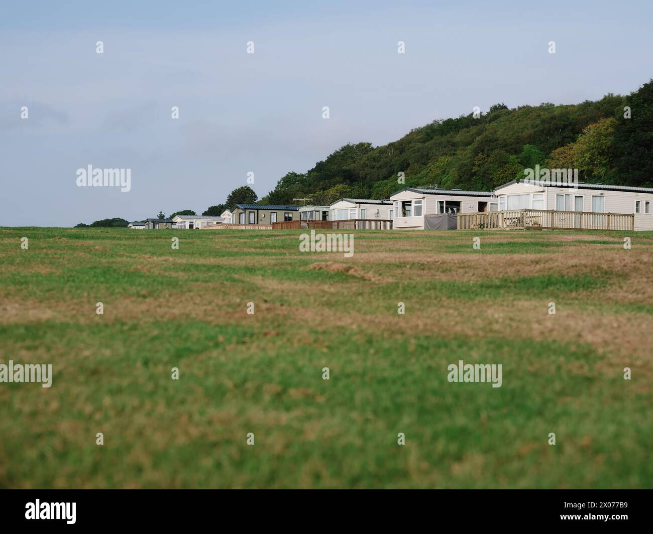 A typical mobile home, static caravan holiday park with grass and sky ...