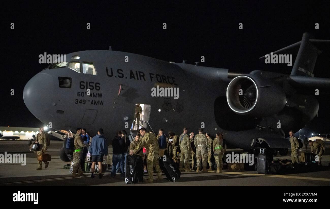 U.S. Airmen with the 21st Airlift Squadron greet and unload equipment ...