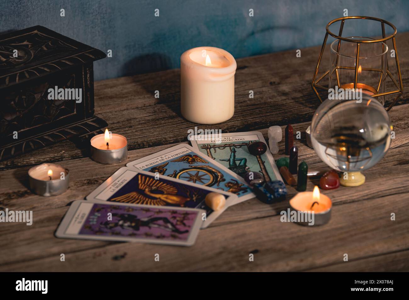 Close-up of a tarot card arrangement with a crystal ball and flickering ...
