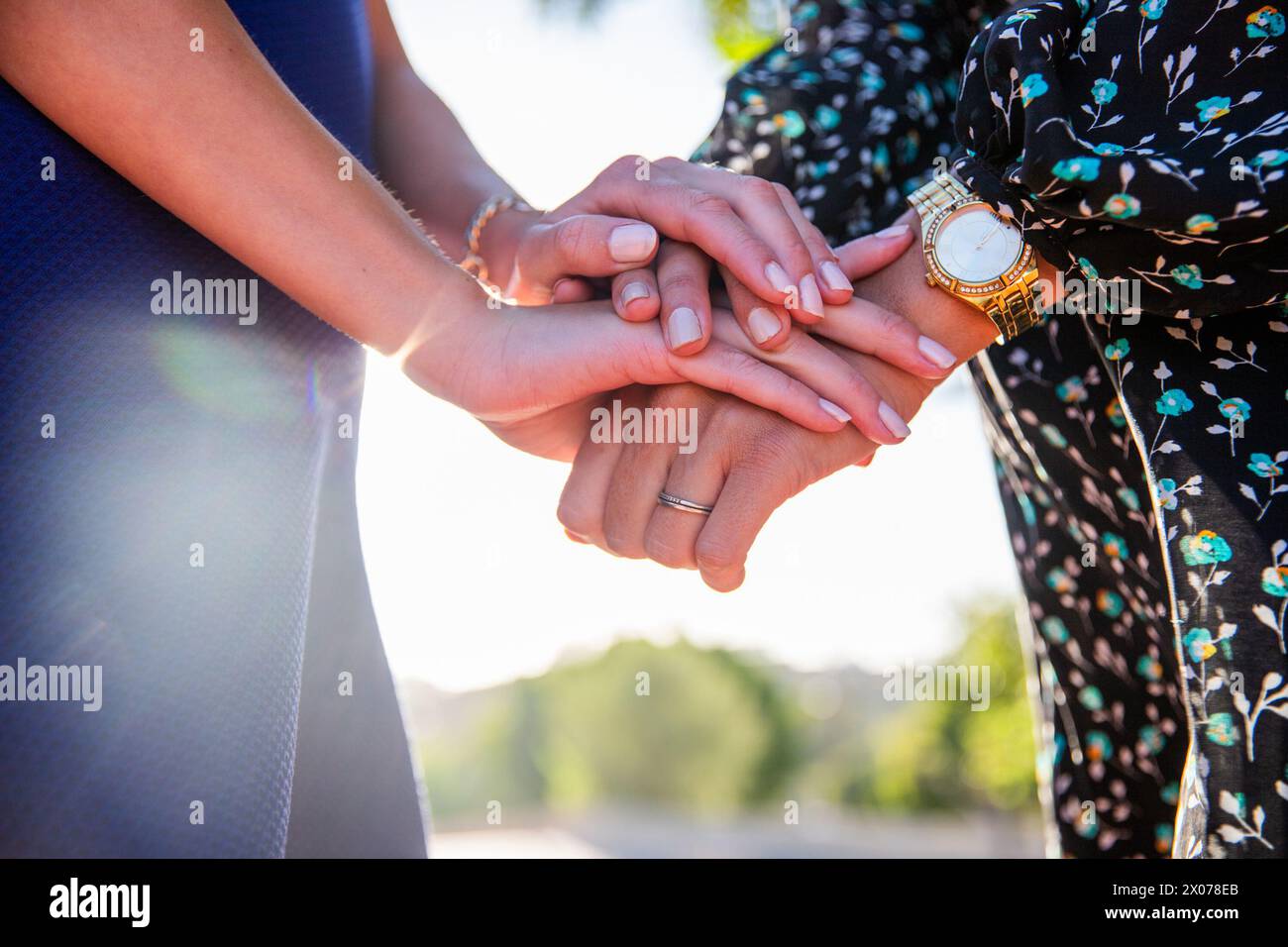 Hands placed one above the other as a sign of support, help and ...