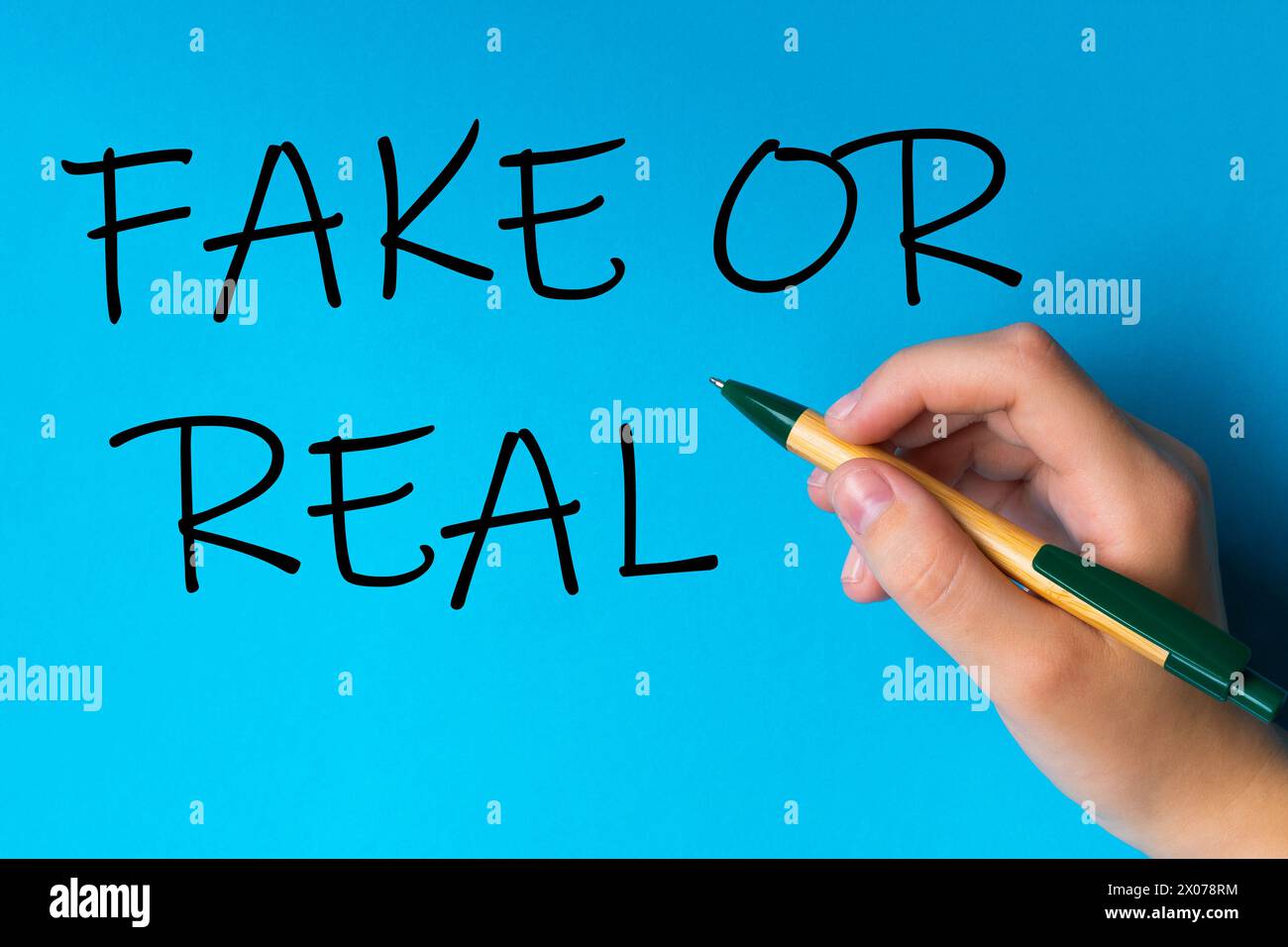Children hand with pen write on a blue white background. Writing hand ...
