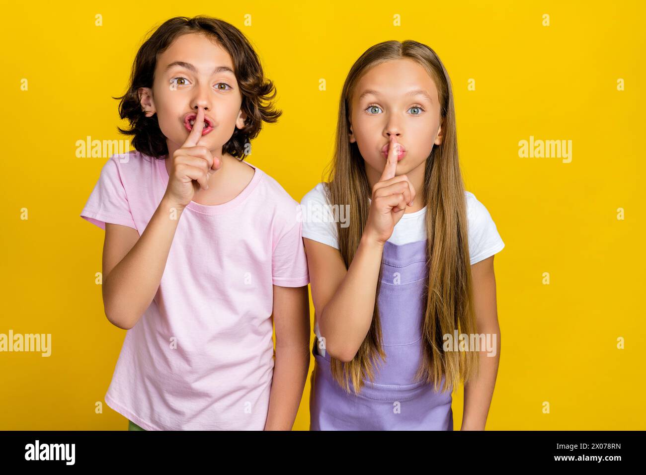 Photo of tricky cunning friends wear casual outfits finger lips asking ...