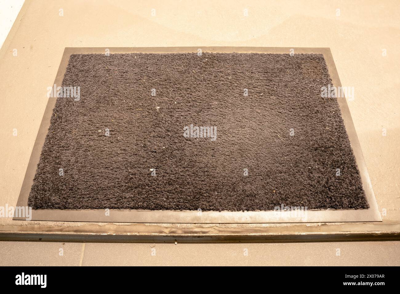 Dirty doormat lying in front of entrance to apartment. Lots of ...