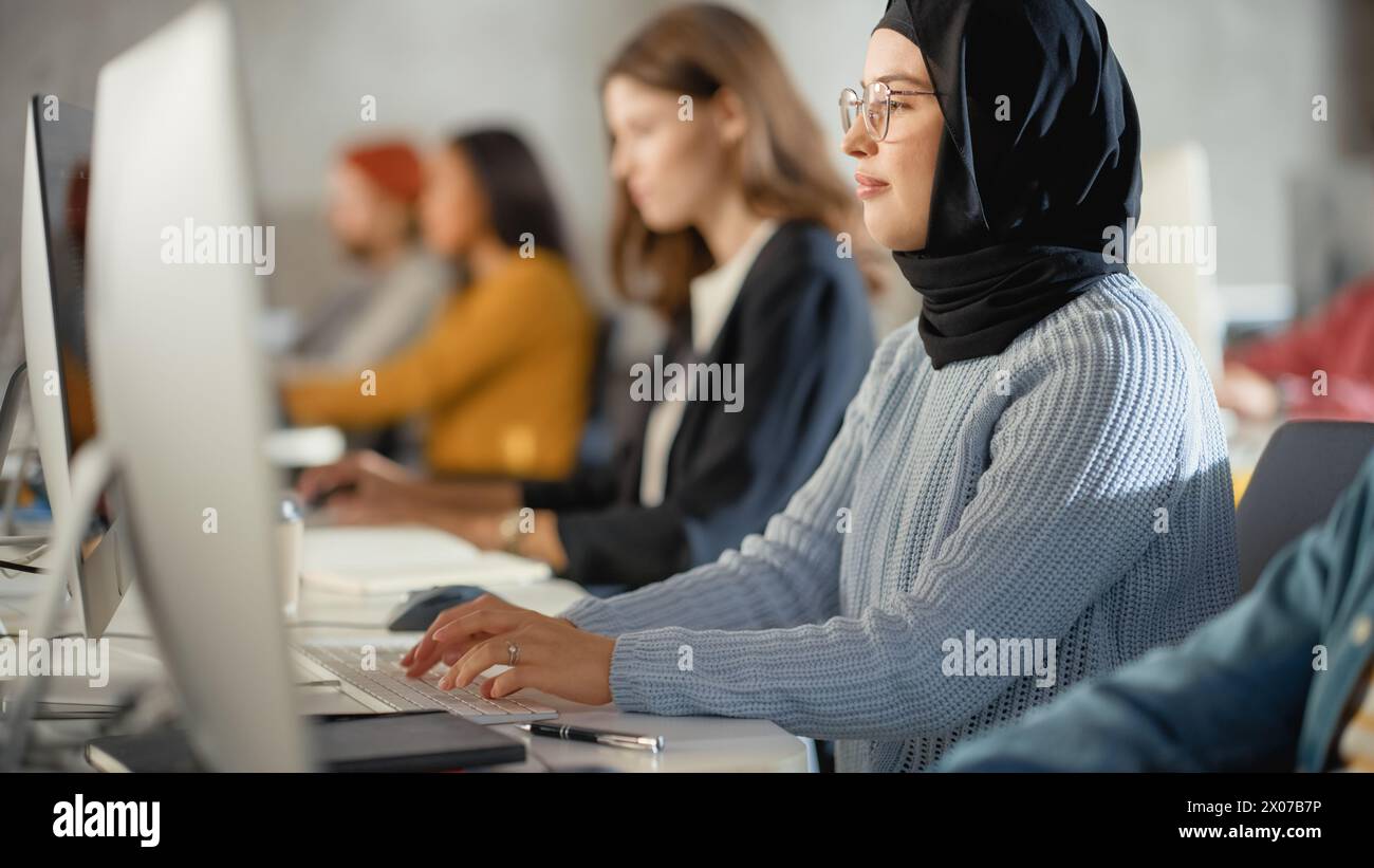 Curious Female Muslim Student Wearing a Hijab, Studying in Modern ...