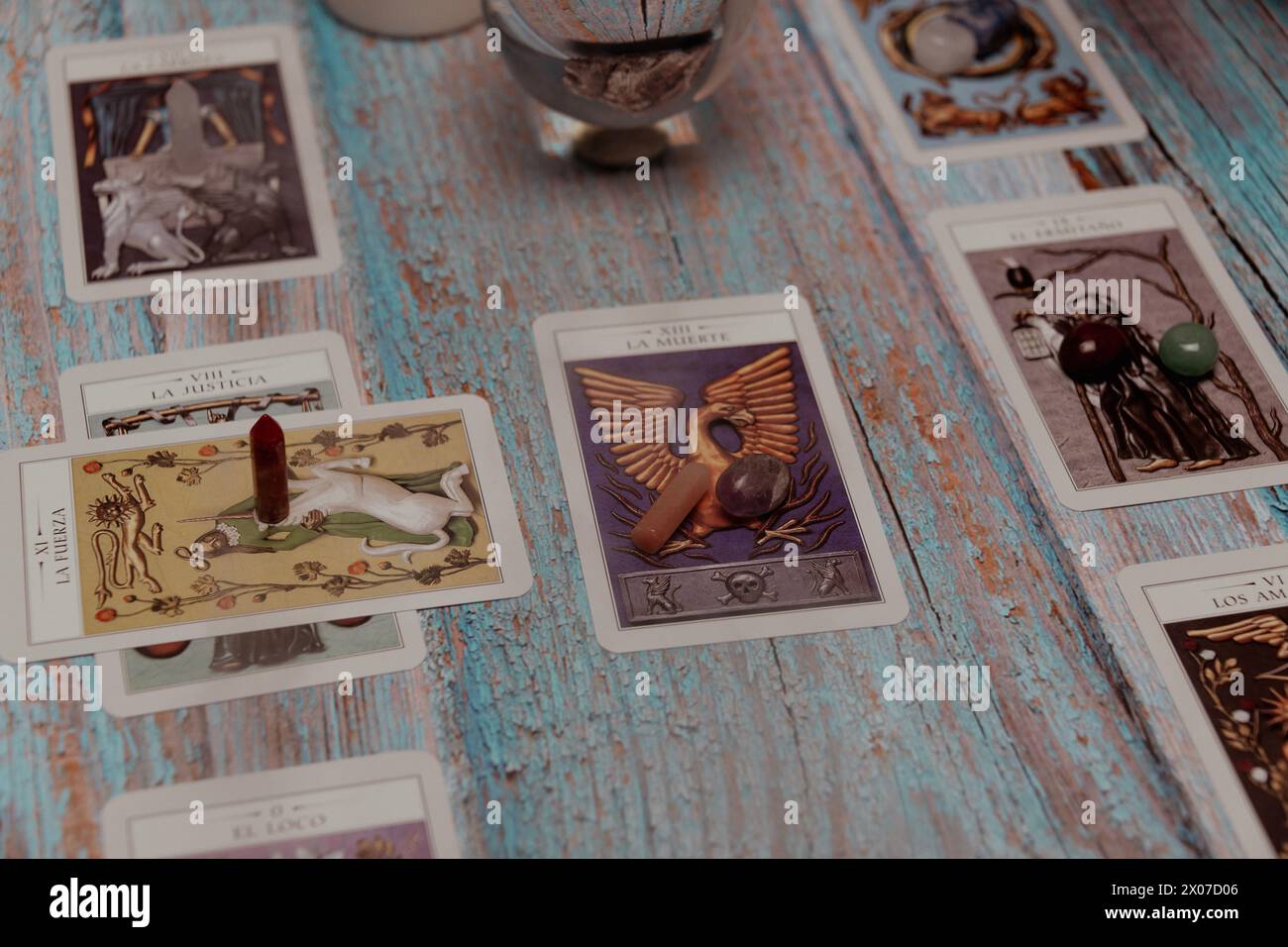 A tarot card reading session depicted with candles, crystals, and ...