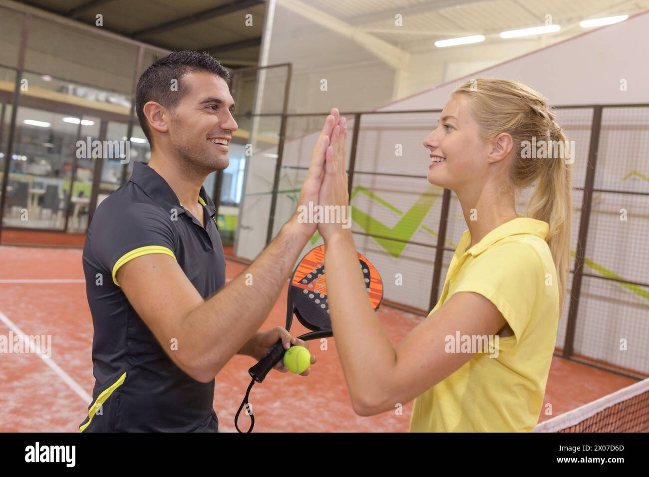 woman tennis player doing high five with her coach Stock Photo - Alamy