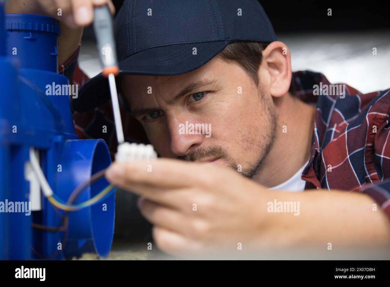 electrician using screwdriver on electrical junction box Stock Photo ...