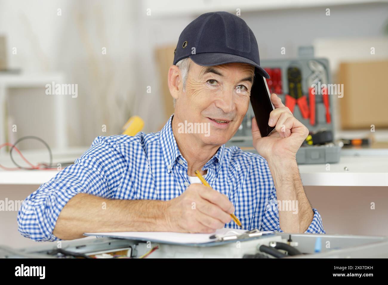 handyman fixing a device indoors Stock Photo - Alamy