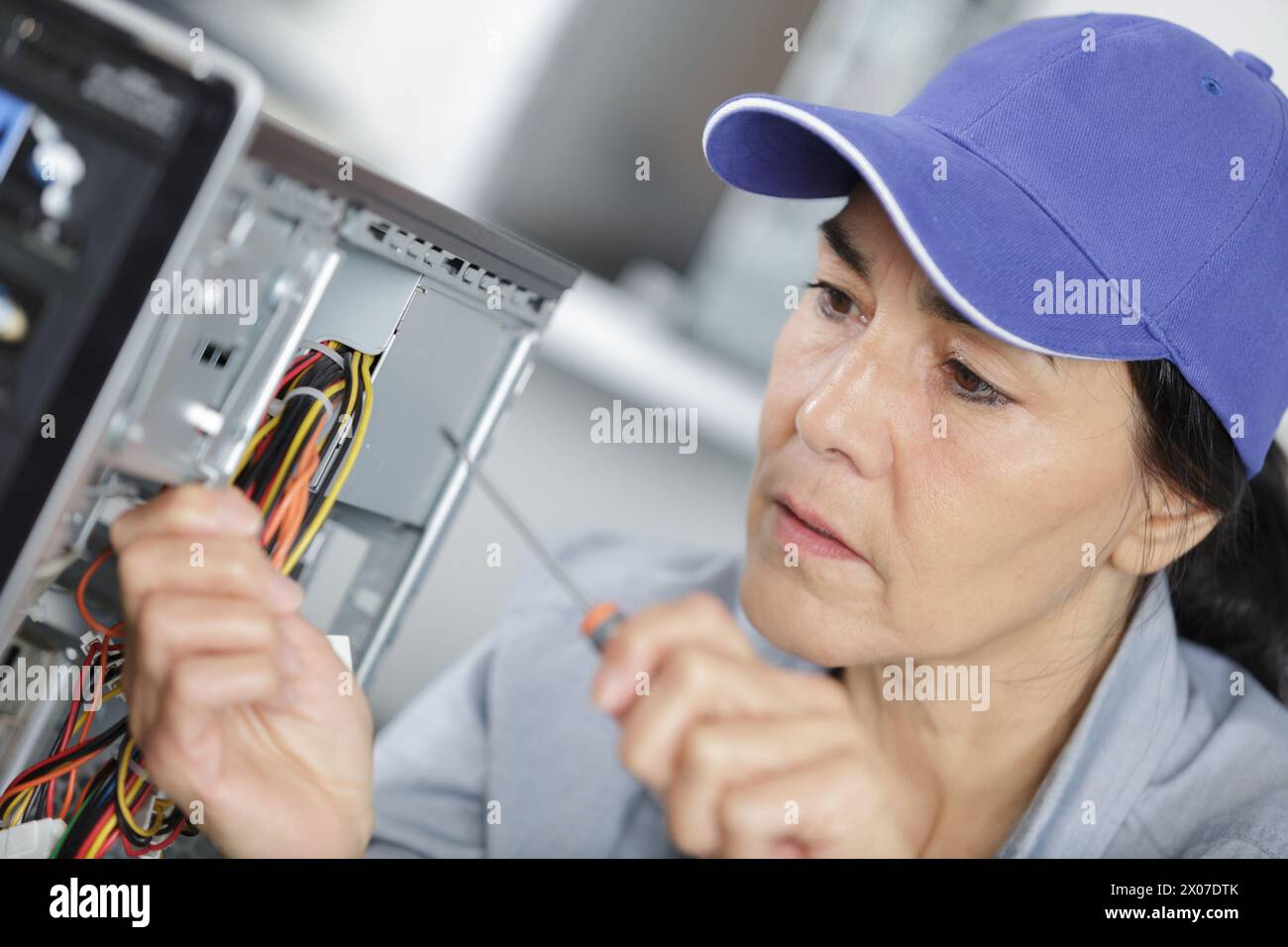 a mature woman checking computer Stock Photo - Alamy